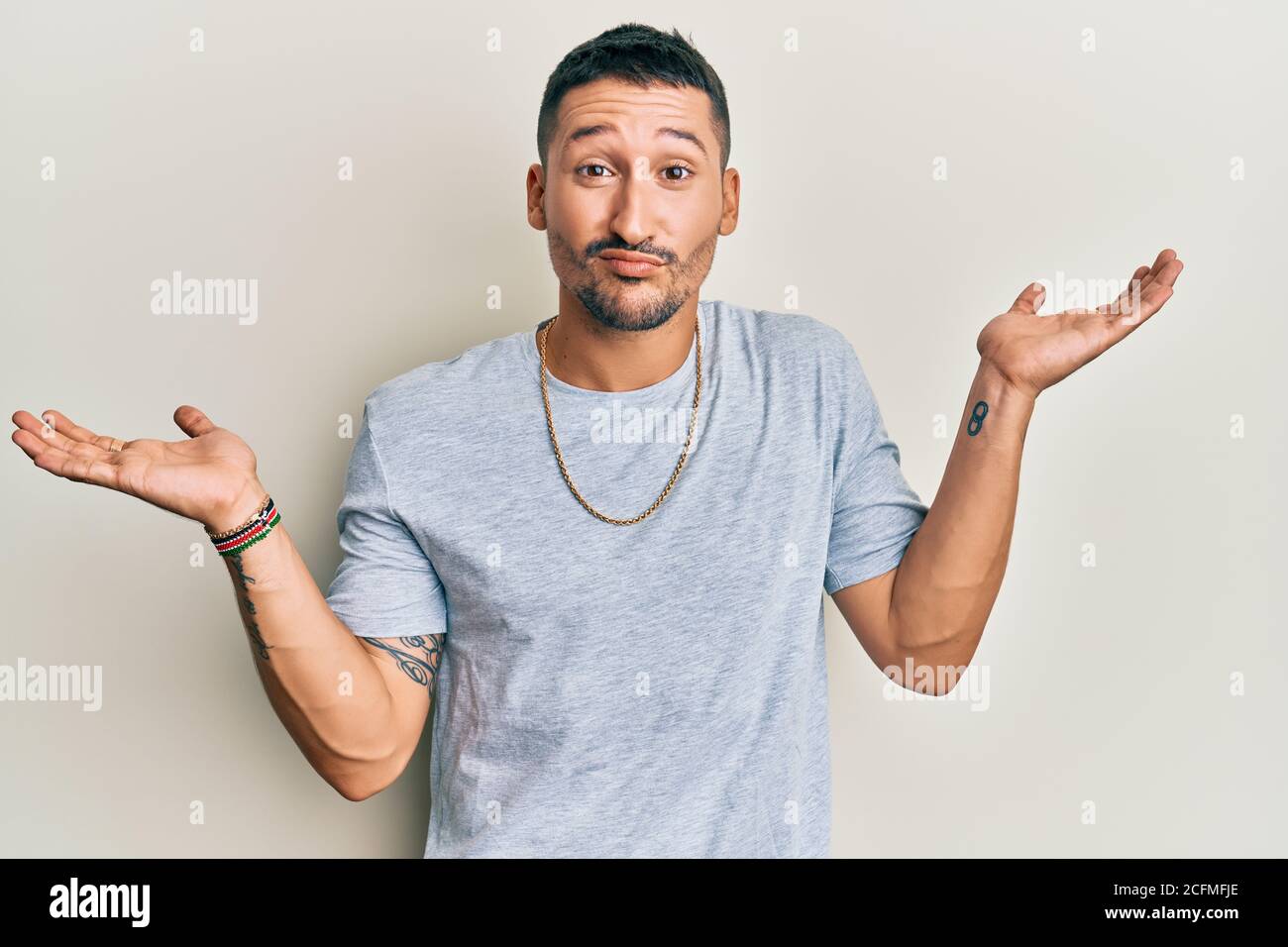 Handsome man with tattoos wearing casual 90s style and gold chain ...