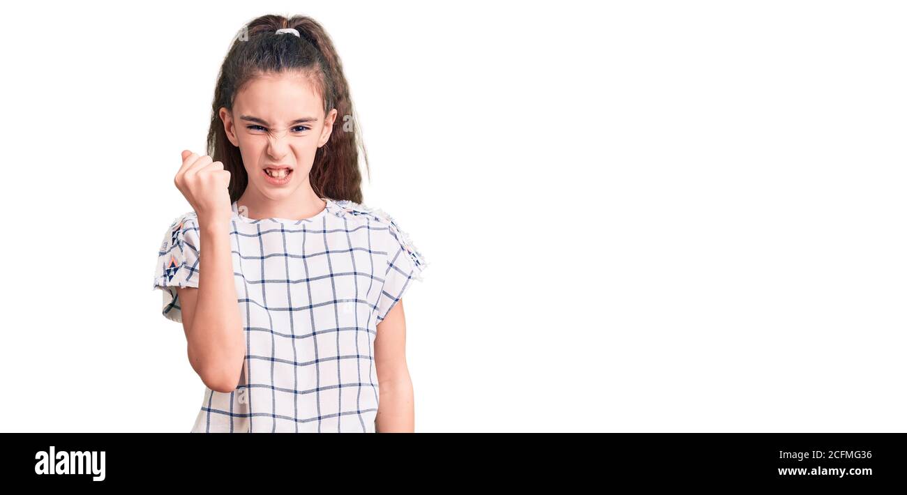 Cute hispanic child girl wearing casual clothes angry and mad raising ...