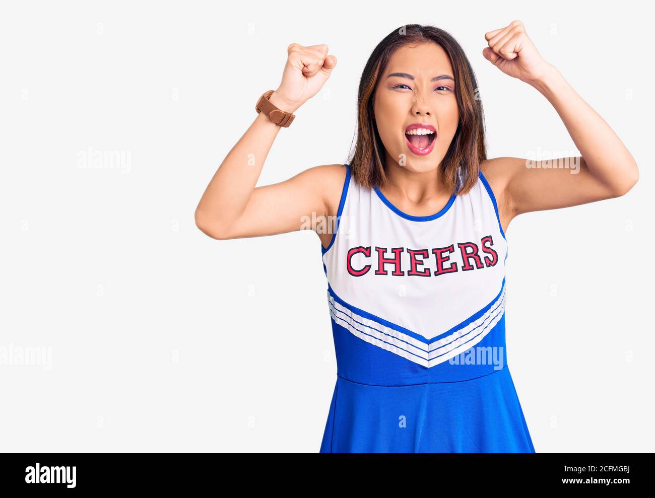 Young beautiful chinese girl wearing cheerleader uniform angry and mad ...