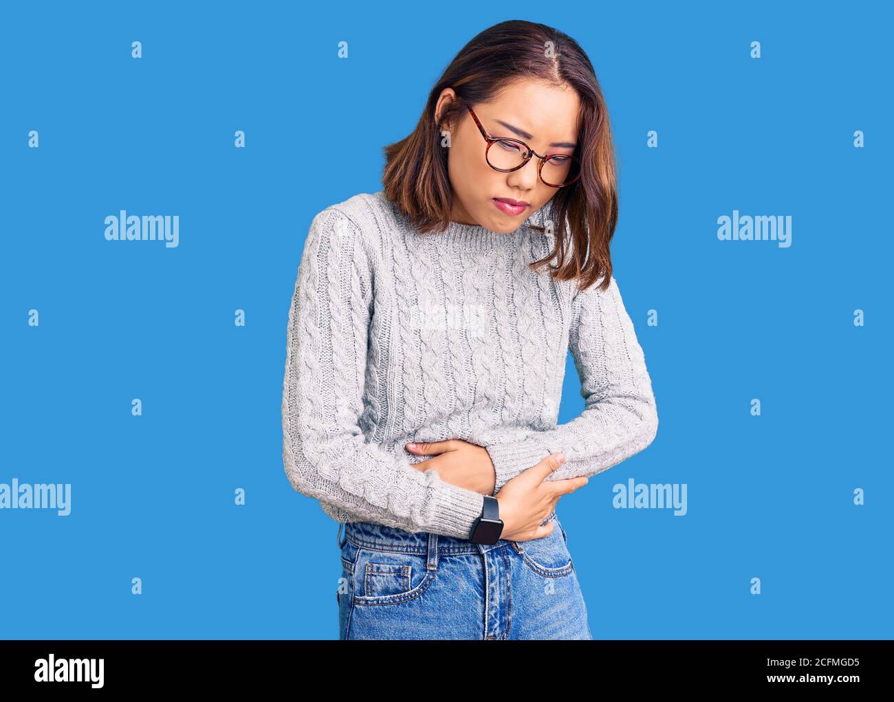 Young beautiful chinese girl wearing casual clothes with hand on ...