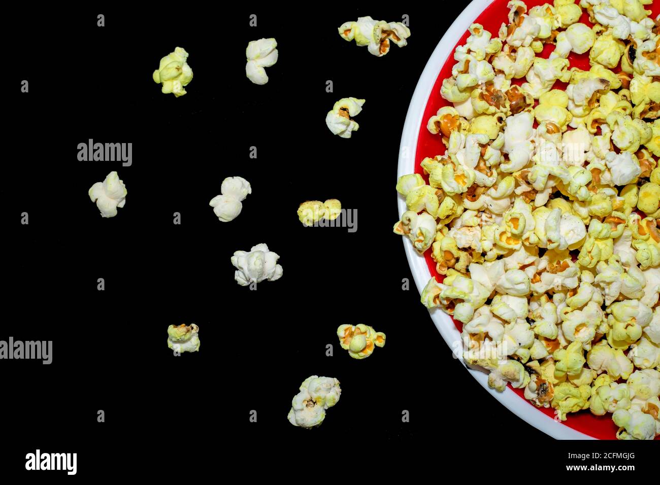 Spilled popcorn on a black background, cinema, movies and entertainment ...