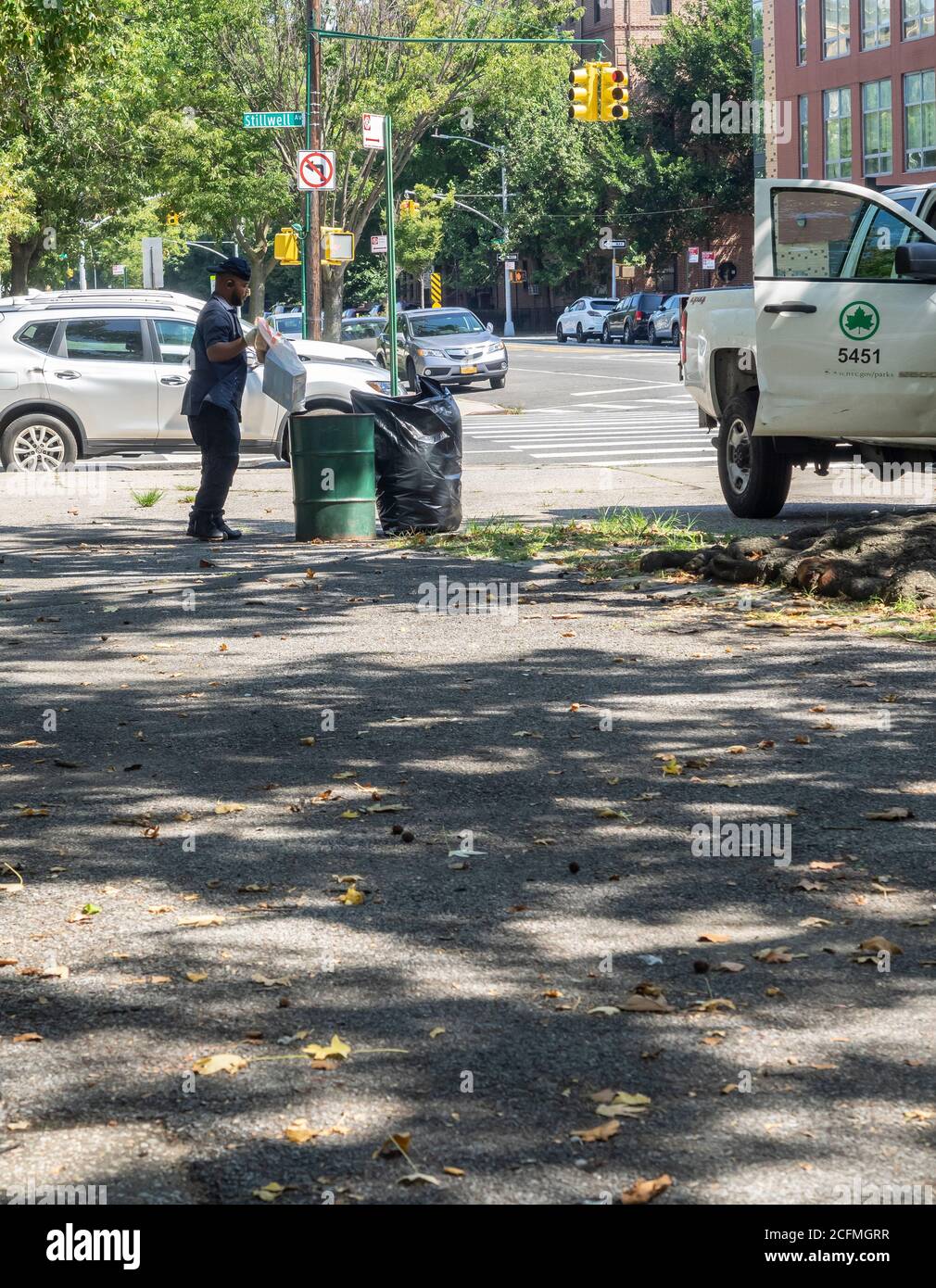 Brooklyn, NY, USA - September 5, 2020: City park worker cleaning trash ...