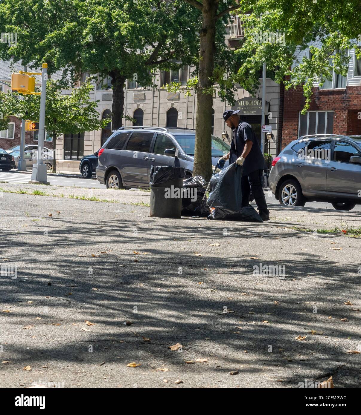 Brooklyn, NY, USA - September 5, 2020: City park worker cleaning trash ...