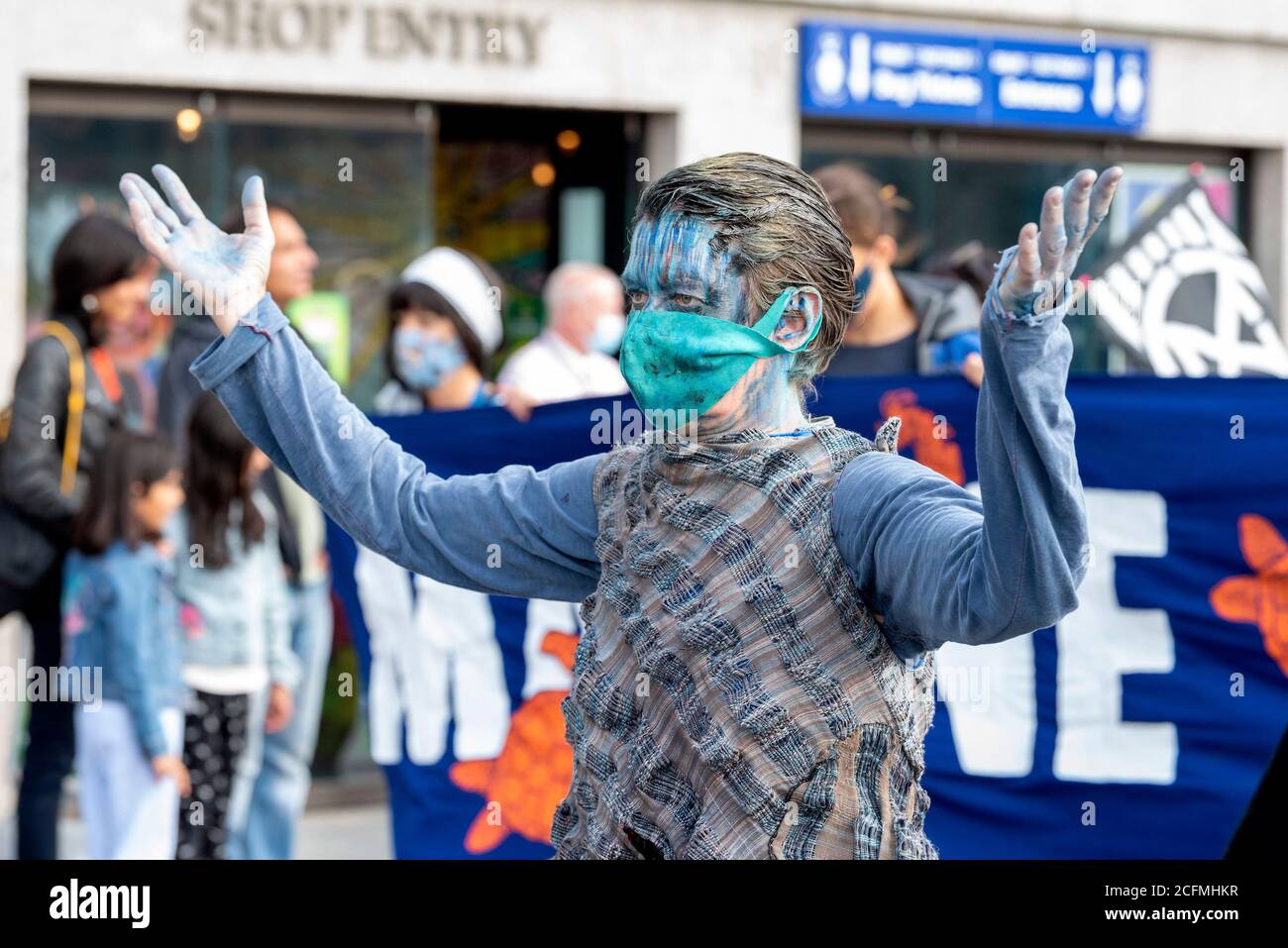 A protester dressed to represent pollution in the oceans takes part ...