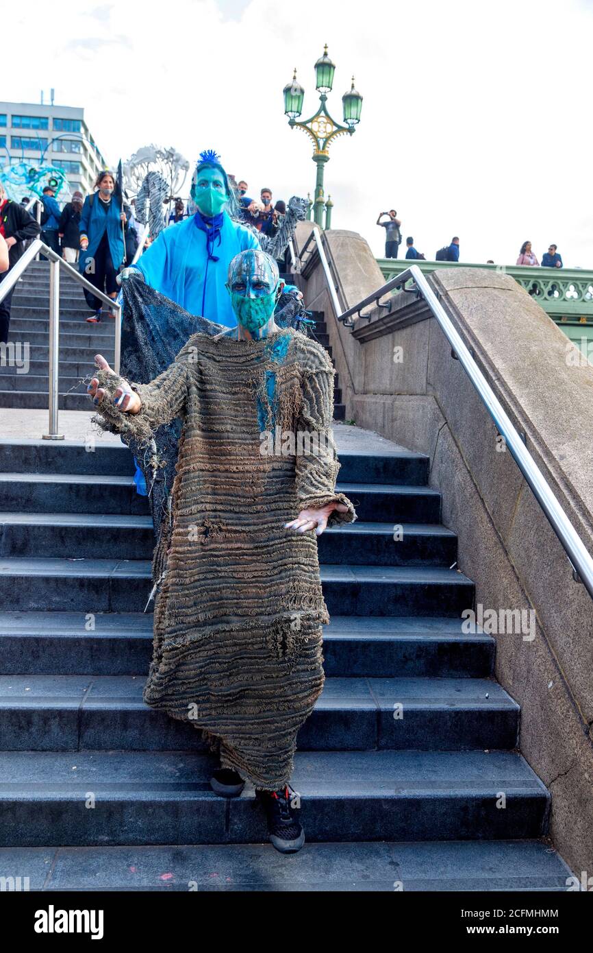 A protester dressed to represent pollution in the oceans takes part ...