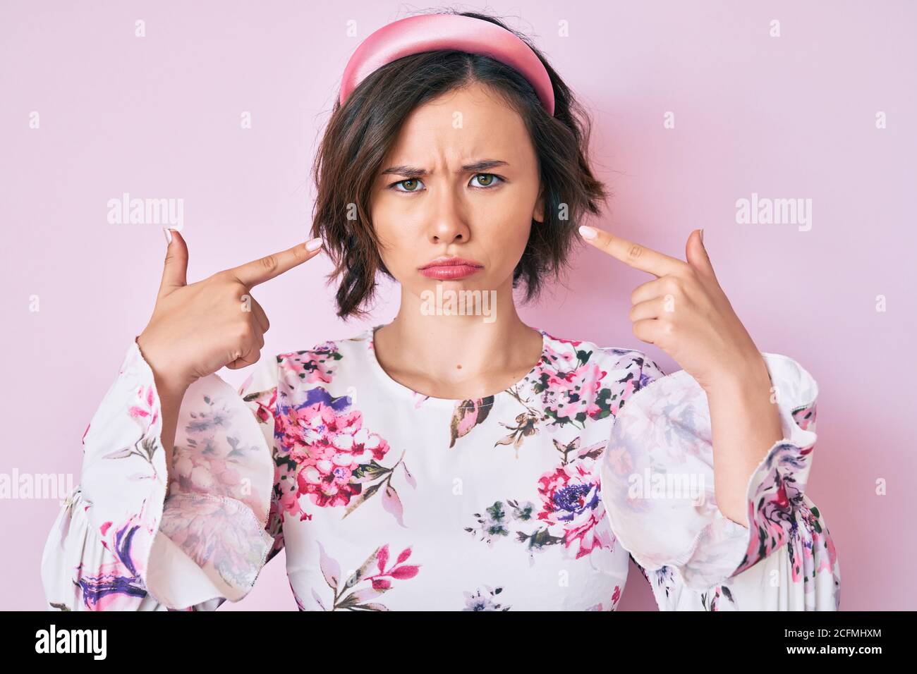 Young beautiful woman pointing with fingers to herself depressed and ...