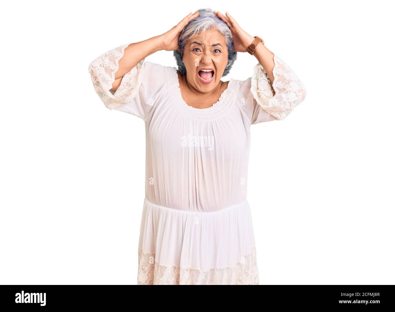Senior woman with gray hair wearing bohemian style crazy and scared ...