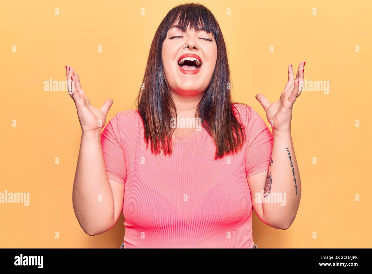 Young plus size woman wearing casual clothes celebrating mad and crazy ...