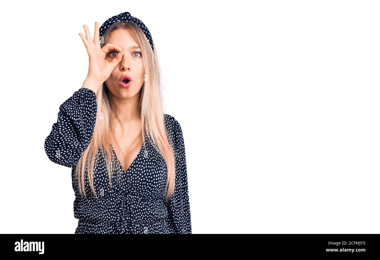 Young beautiful blonde woman wearing casual clothes doing ok gesture ...