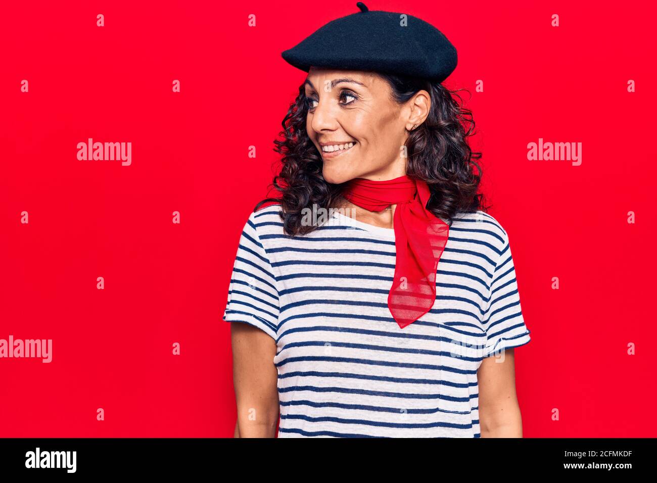 Middle age beautiful woman wearing french beret looking to side, relax ...