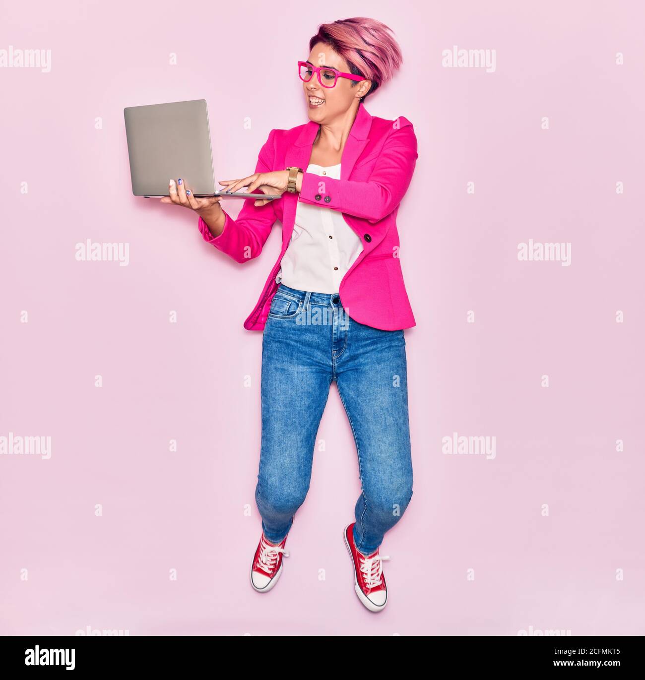 Young beautiful businesswoman with pink short hair wearing glasses ...