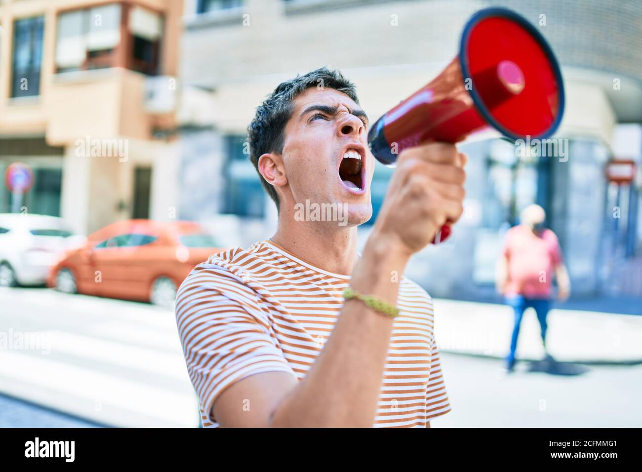 Young man walking megaphone hi-res stock photography and images - Alamy