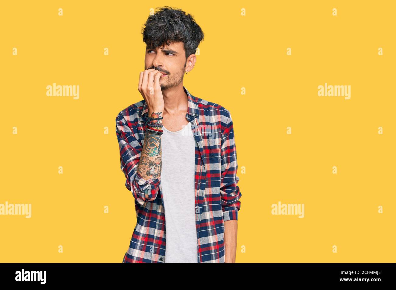 Young hispanic man wearing casual clothes looking stressed and nervous ...