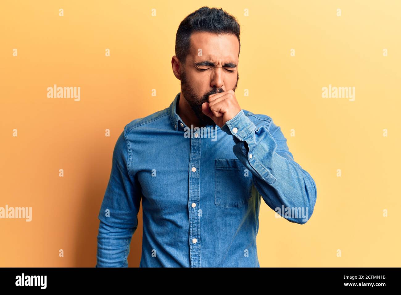 Young hispanic man wearing casual clothes feeling unwell and coughing ...