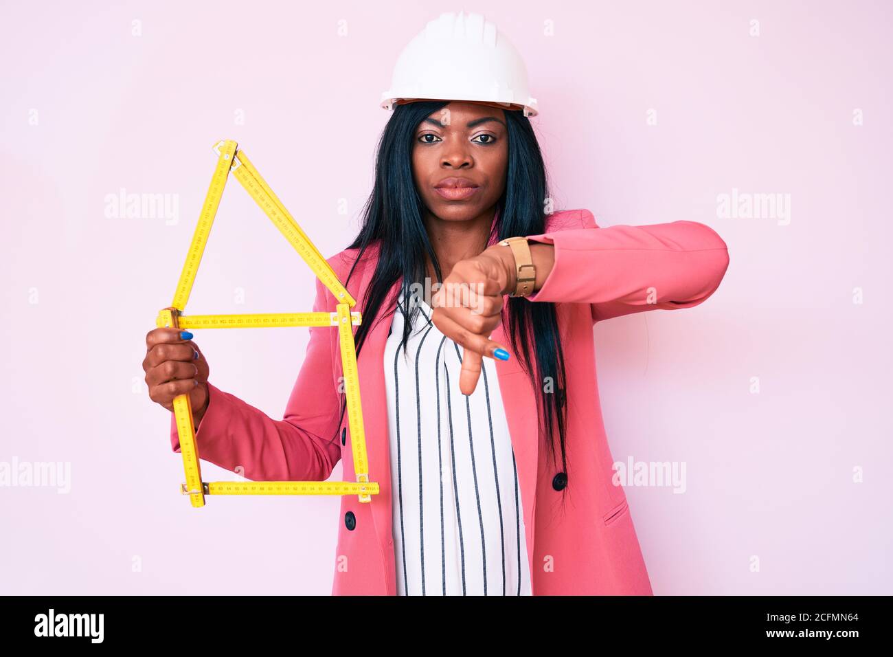 Young african american woman wearing bike helmet and holding water ...