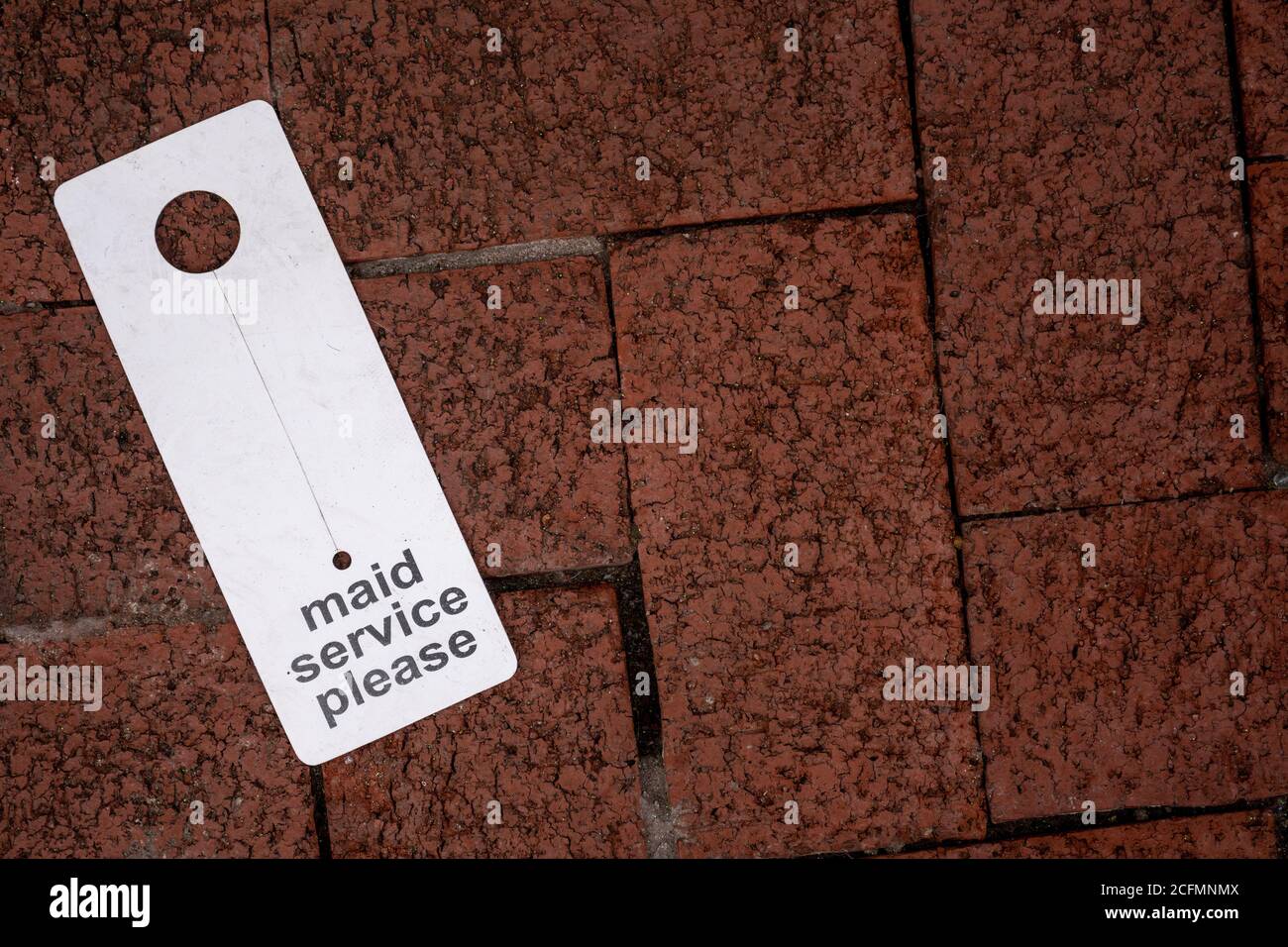 Maid Service Please hang sign on brick ground Stock Photo - Alamy