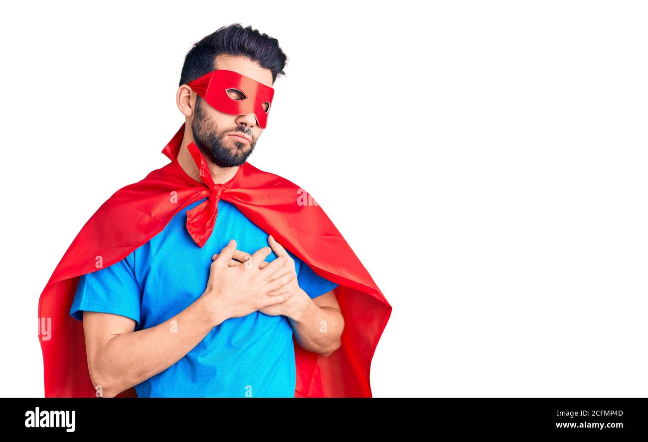 Young handsome man with beard wearing super hero costume smiling with ...