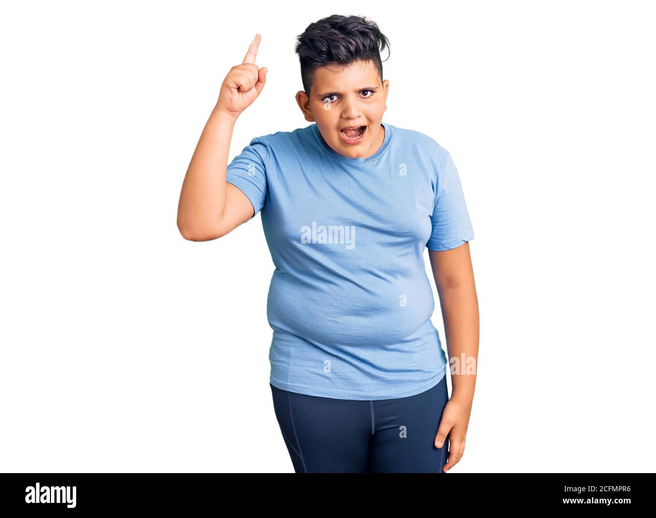 Little boy kid wearing sports workout clothes pointing finger up with ...