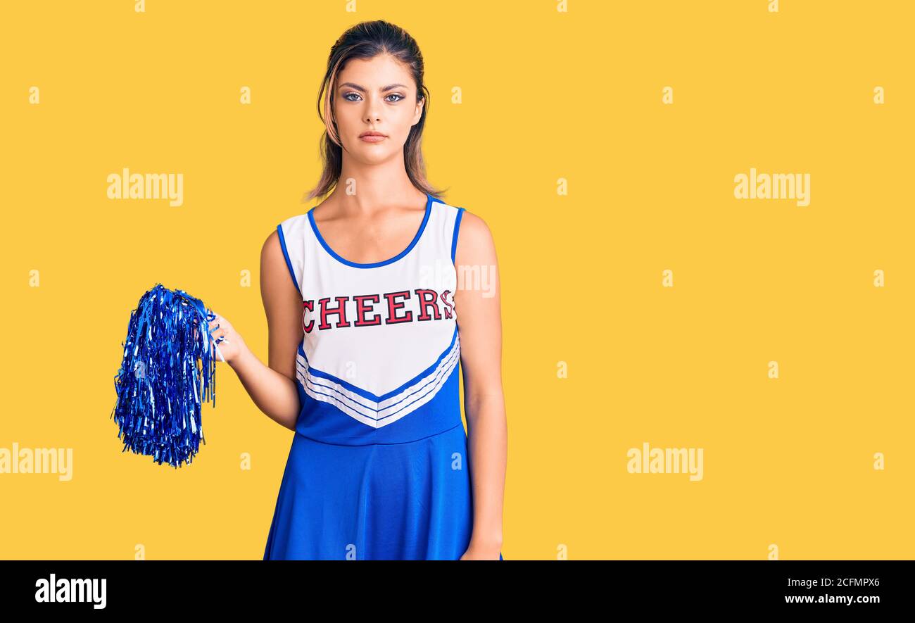 Young beautiful woman wearing cheerleader uniform skeptic and nervous ...