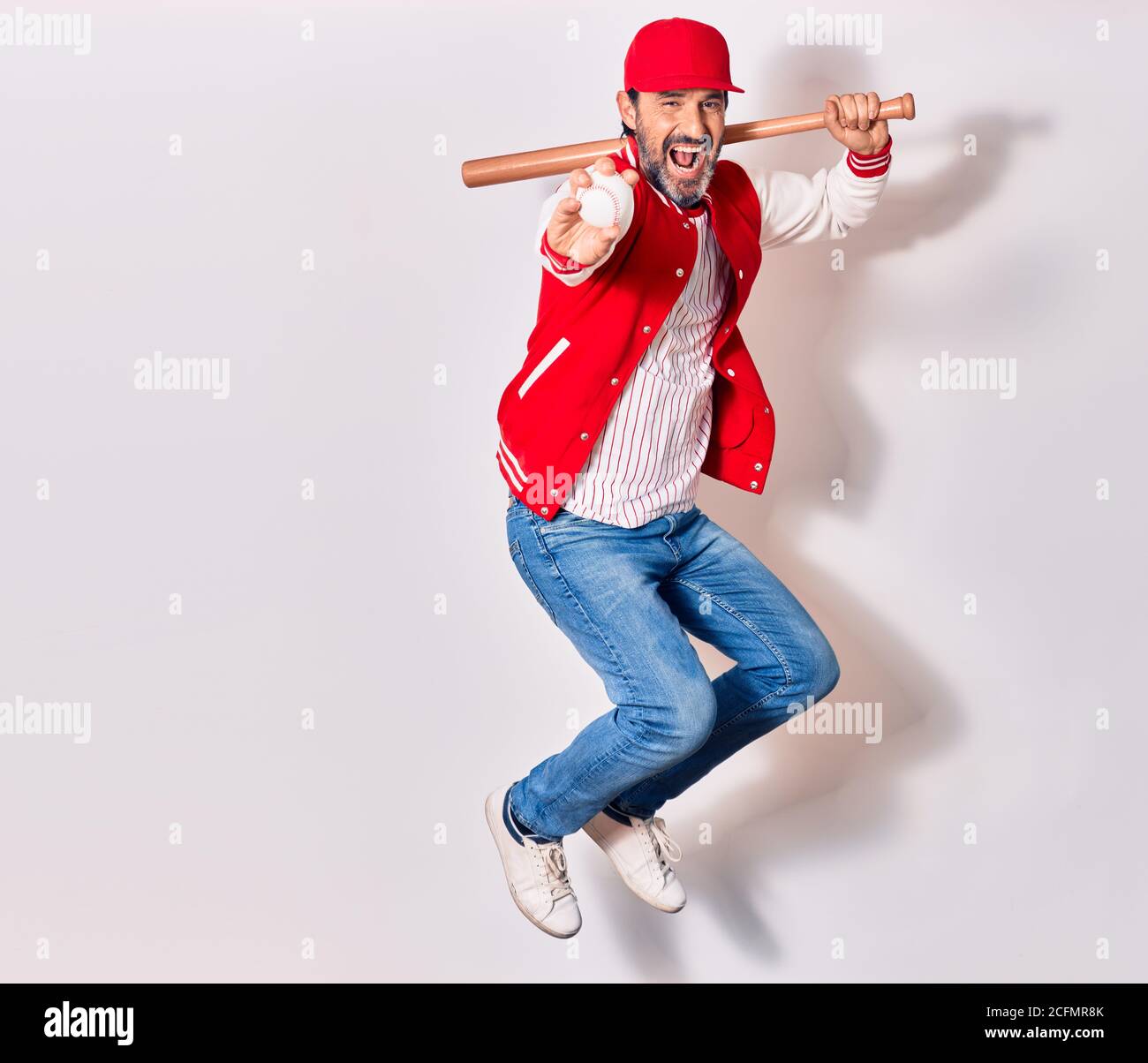 Middle age handsome man wearing sporty clothes smiling happy. Jumping ...