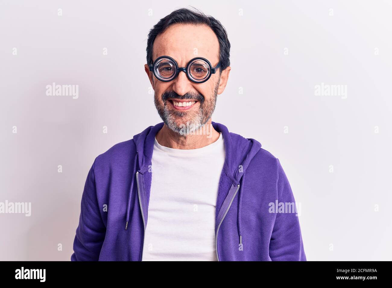 Middle age handsome freaky man wearing dumb glasses over isolated white ...