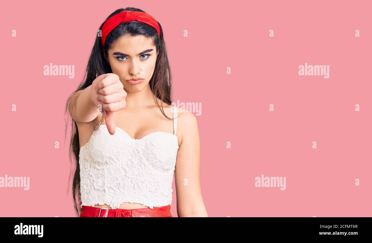 Brunette teenager girl wearing elegant look looking unhappy and angry ...
