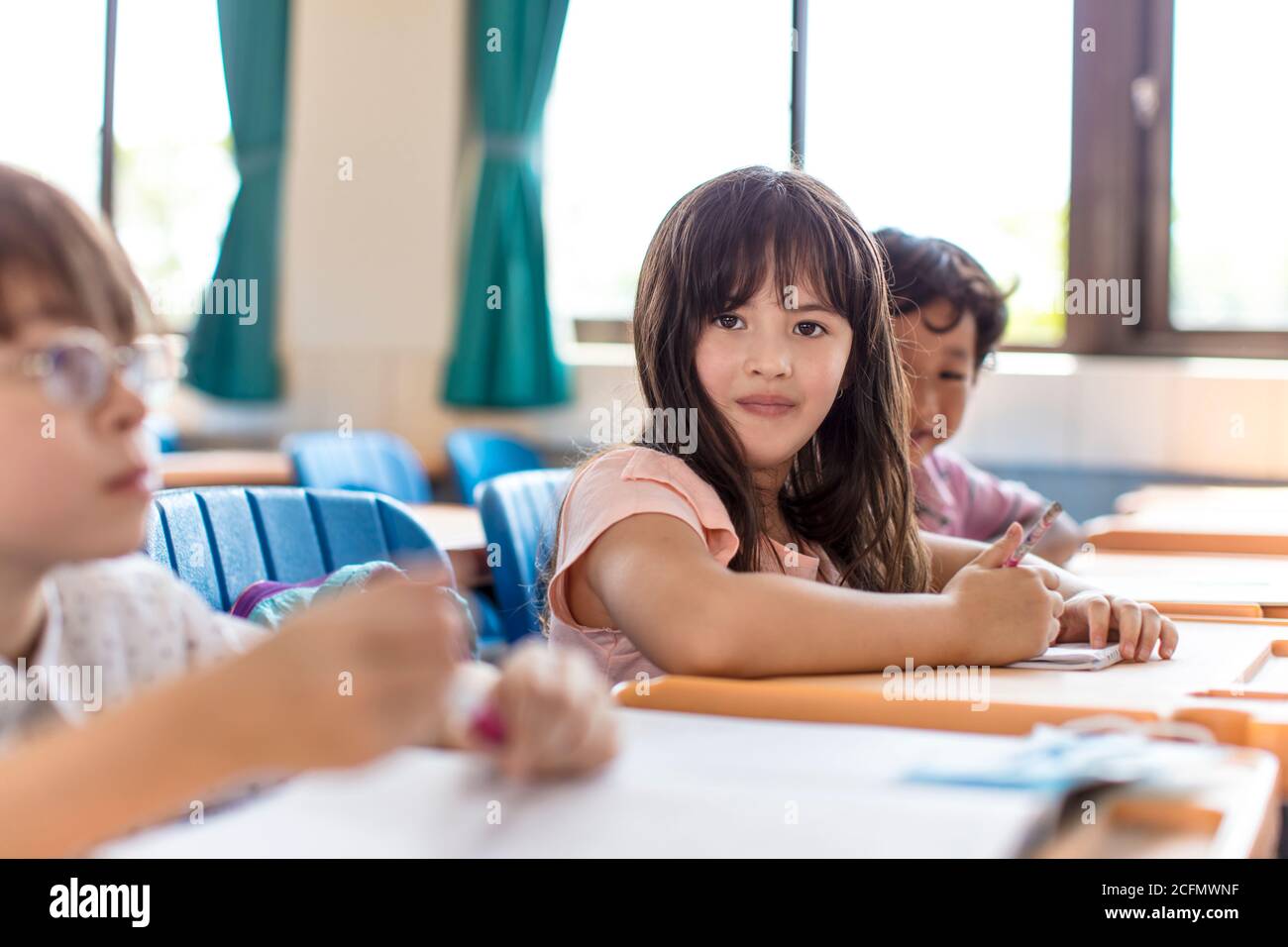beautiful little girl studying in the classroom Stock Photo - Alamy