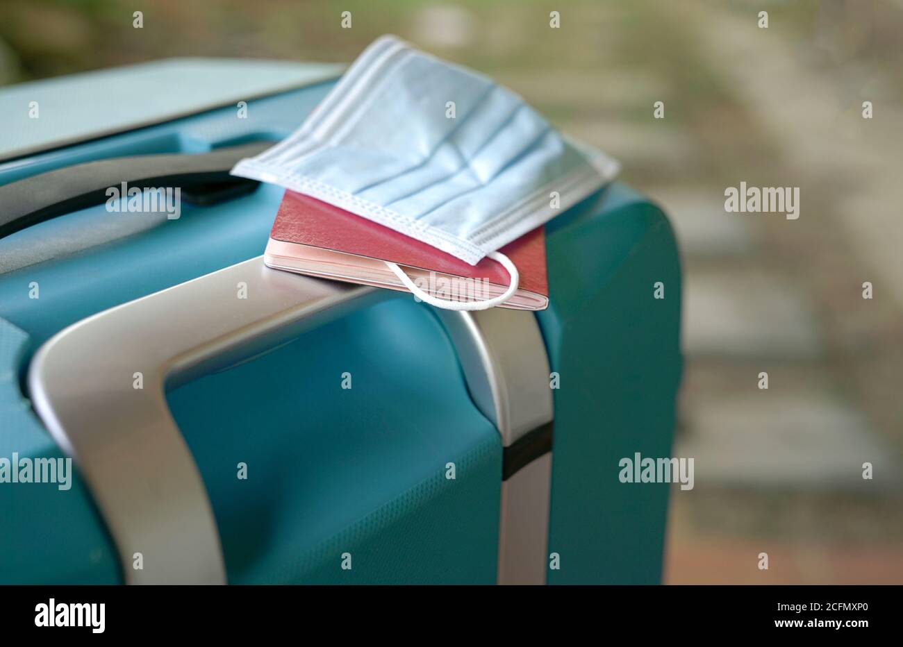 Suitcase with face mask and passport. Travel overseas during Covid-19 ...