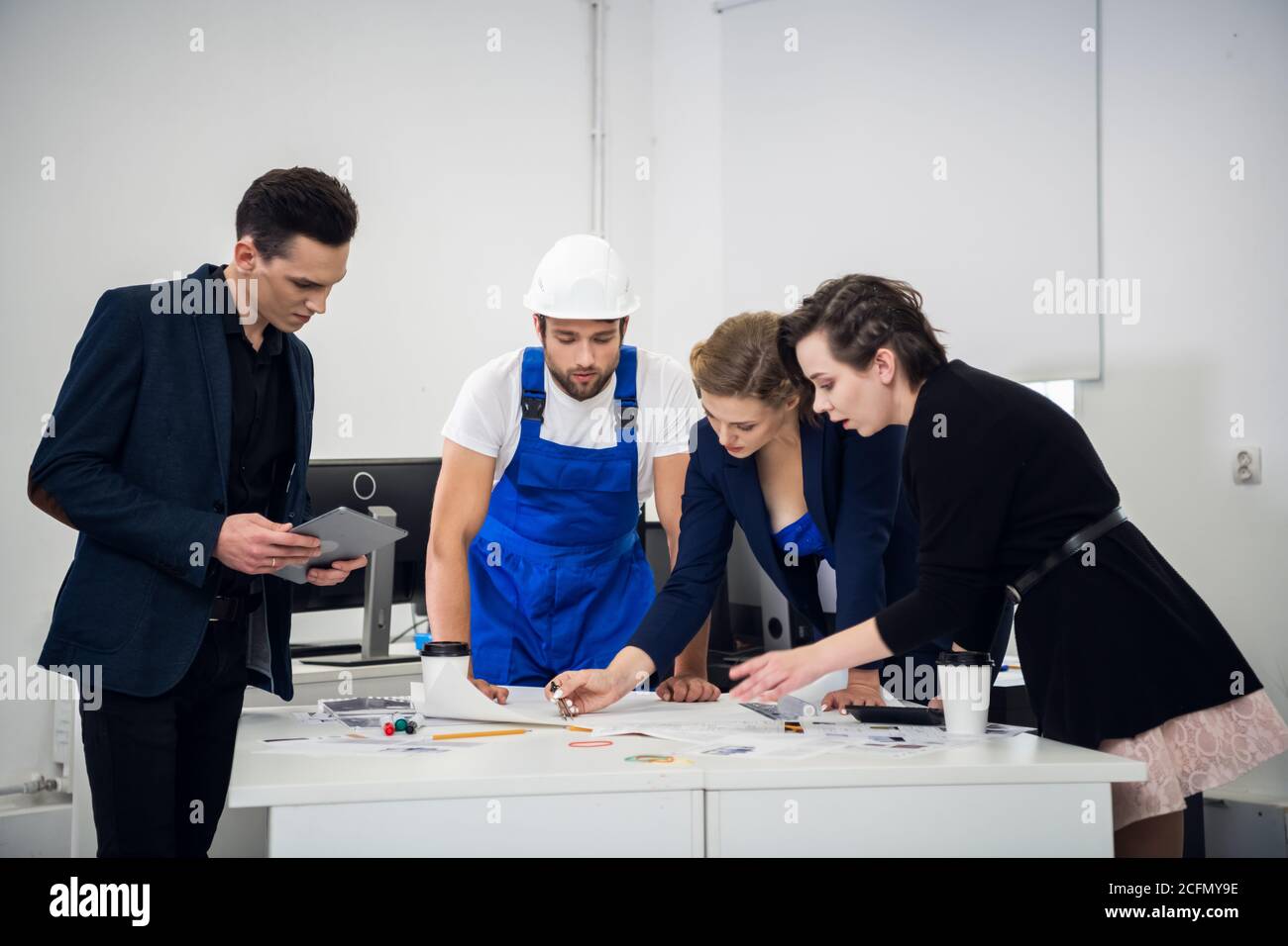 A group of young architects working on a project. Cooperation and team ...