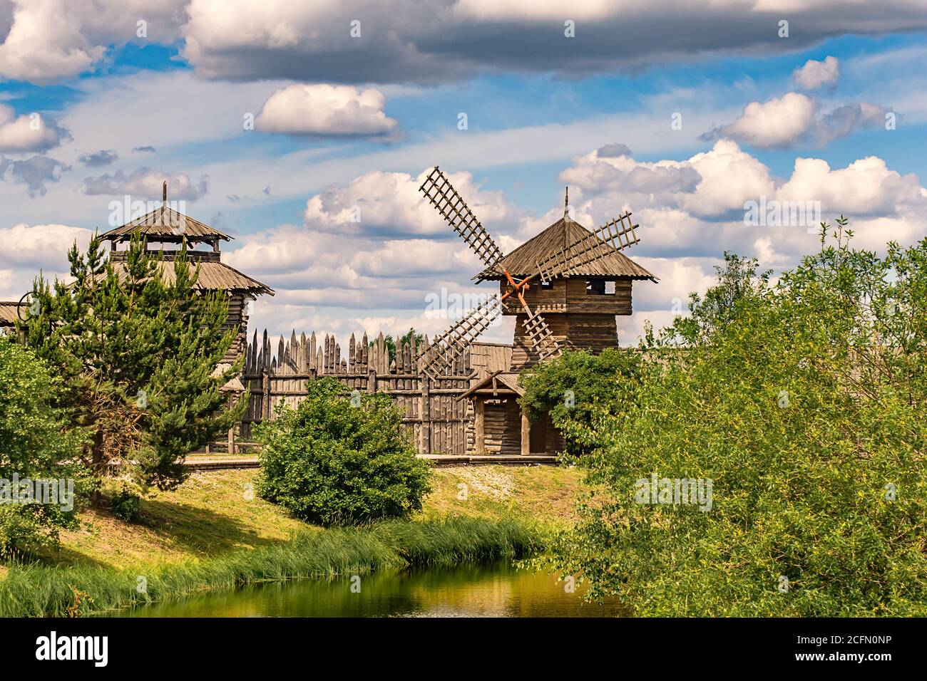 Beautiful wooden ancient Slavic settlement with windmill and tower by ...