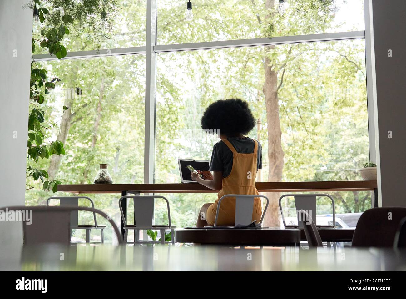 Young black female laptop hi-res stock photography and images - Alamy