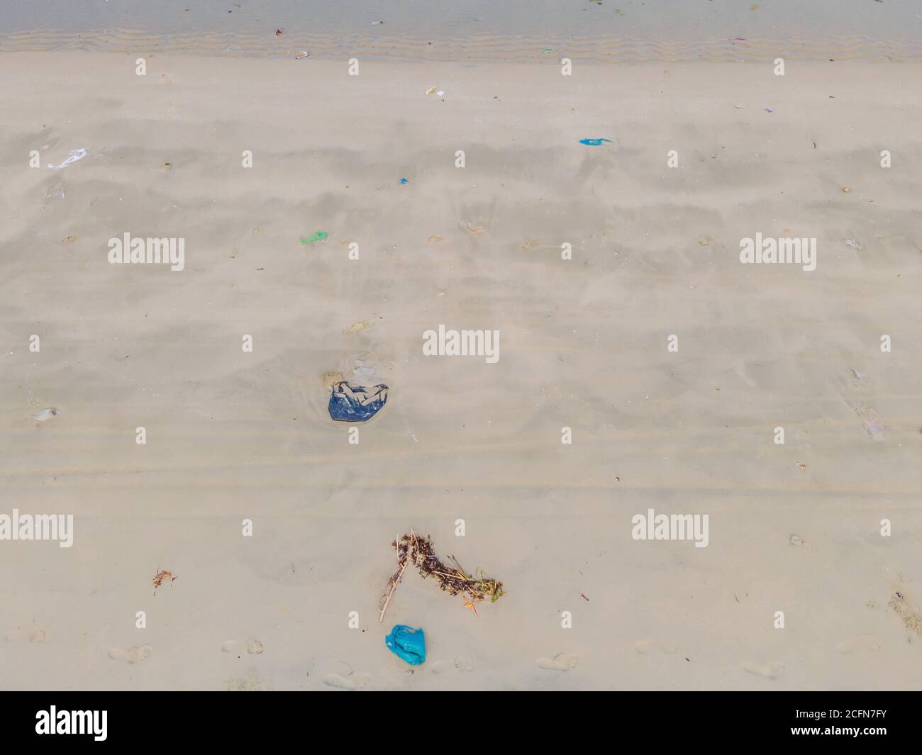 Sandy beach with Plastic garbage and medical waste materials in ...