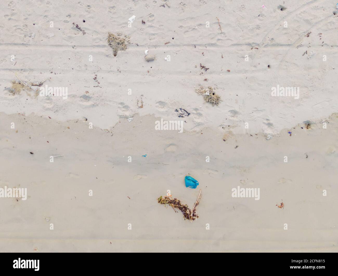 Sandy beach with Plastic garbage and medical waste materials in ...