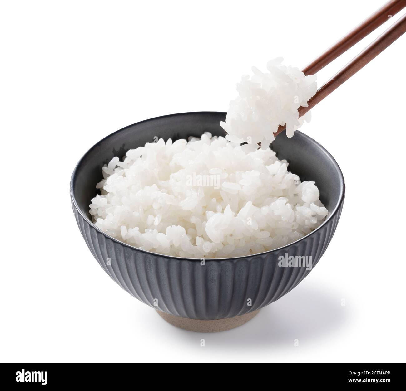 Scooping rice with chopsticks on a white background Stock Photo - Alamy