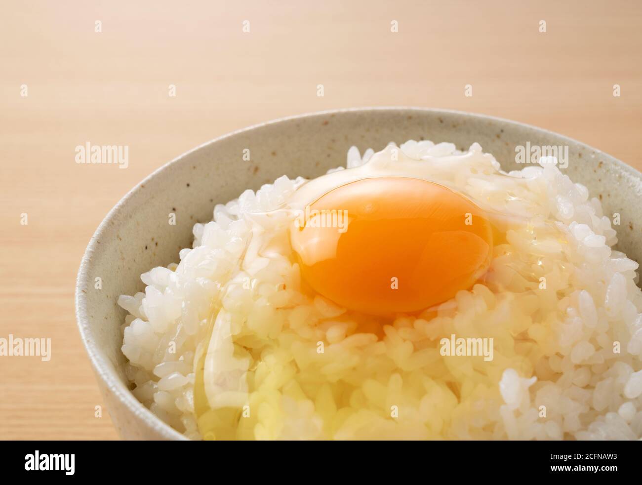 Rice with egg on a wooden backdrop. Traditional Japanese cuisine Stock ...