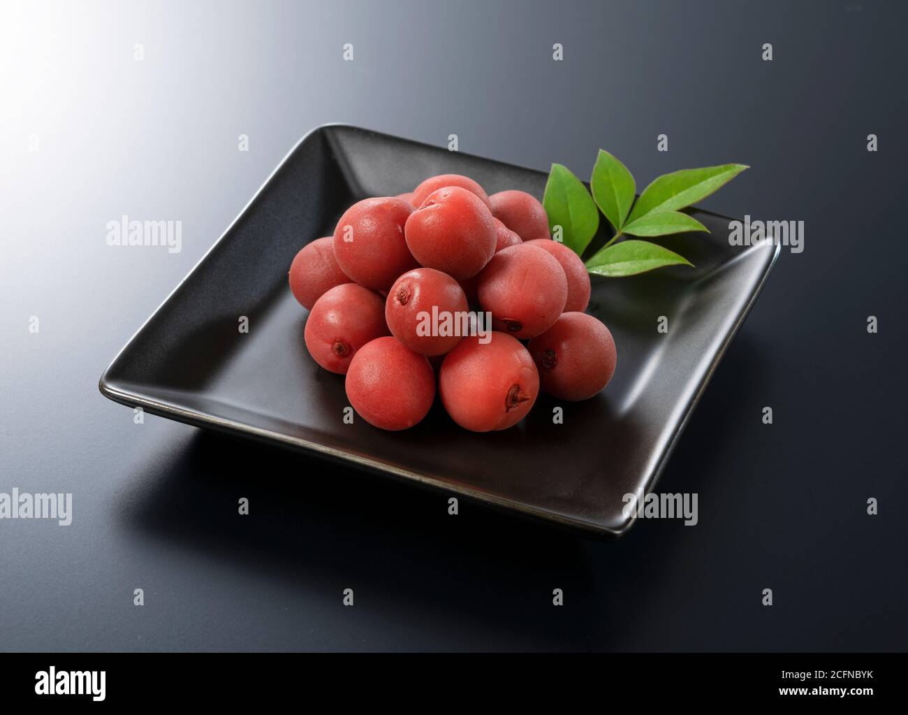 Japanese pickled plums set against a black background. (Koshu Koume ...