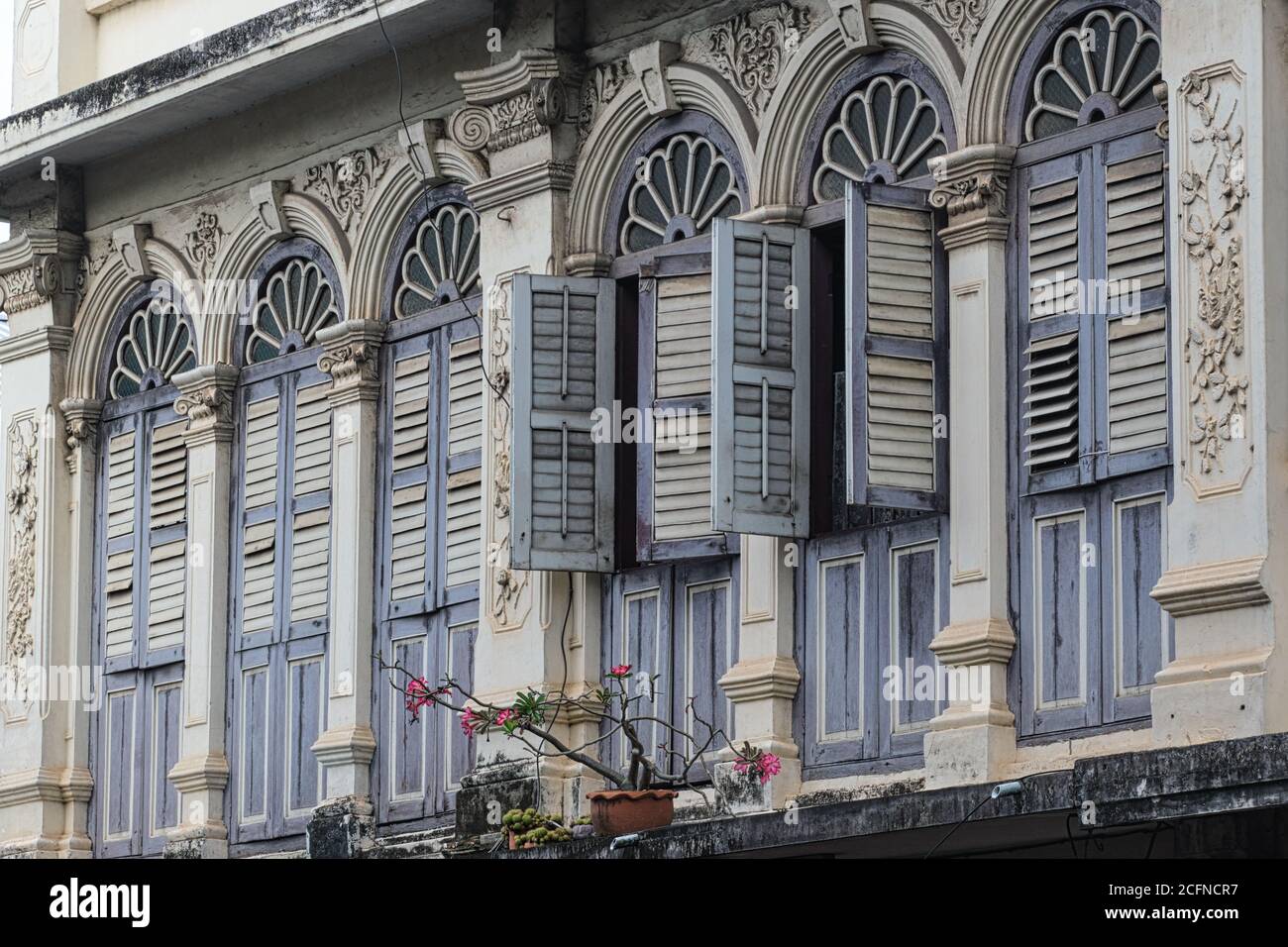 The latticed windows of a withered old Sino-Portguese or Peranakan ...