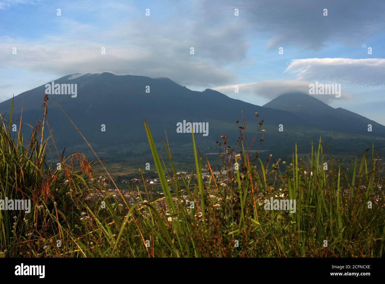 Dome-shaped Mount Gede (left) and the conical Mount Pangrango, the core ...