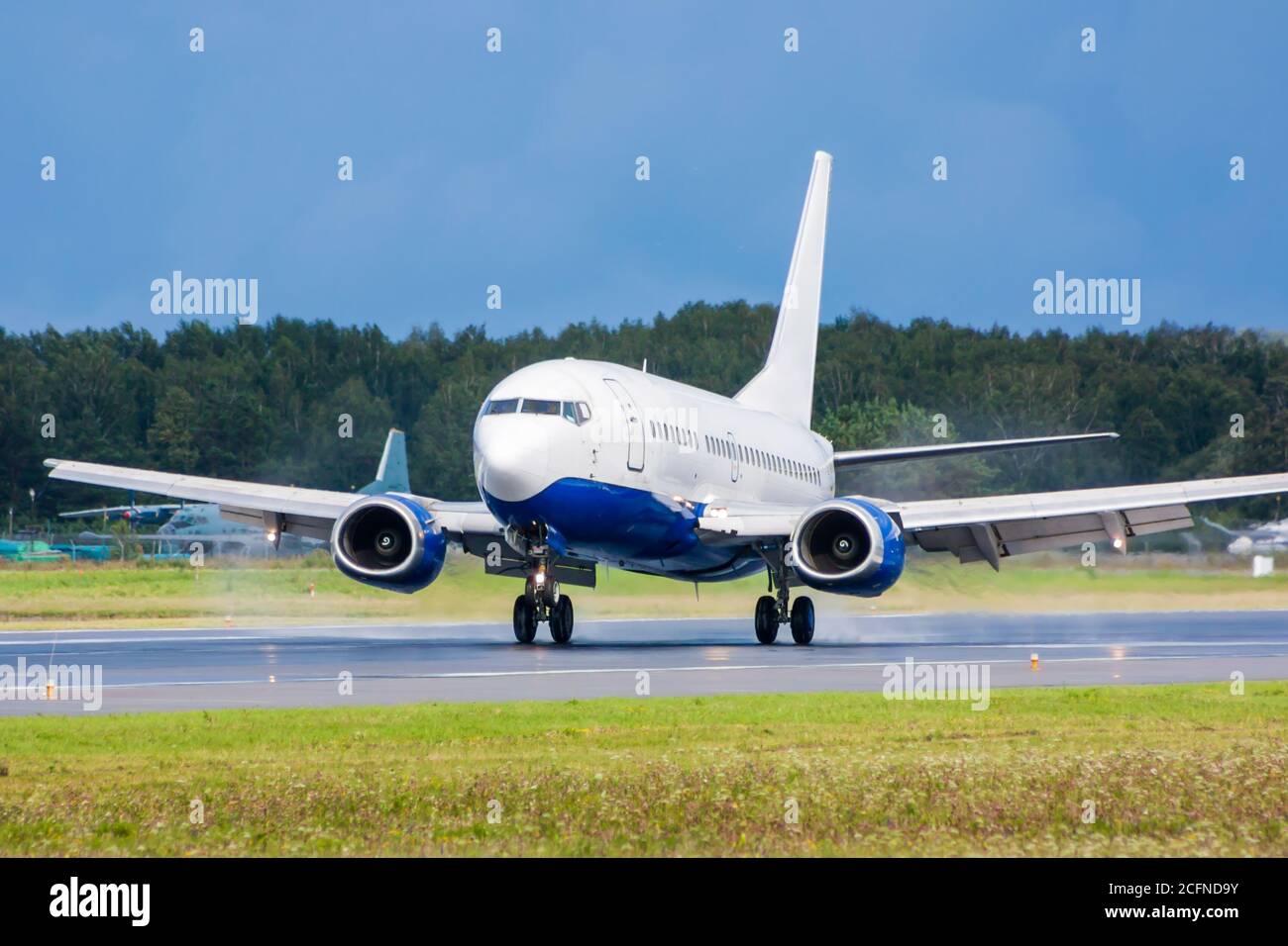 Airplane landing on runway. Touchdown with tire smoke Stock Photo - Alamy