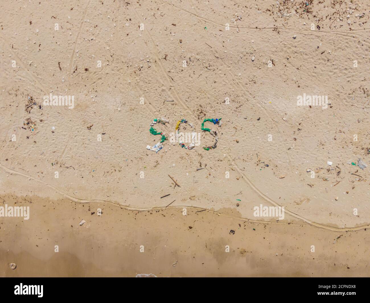 Environmental problem. Ecology concept. Plastic on the beach with sos ...