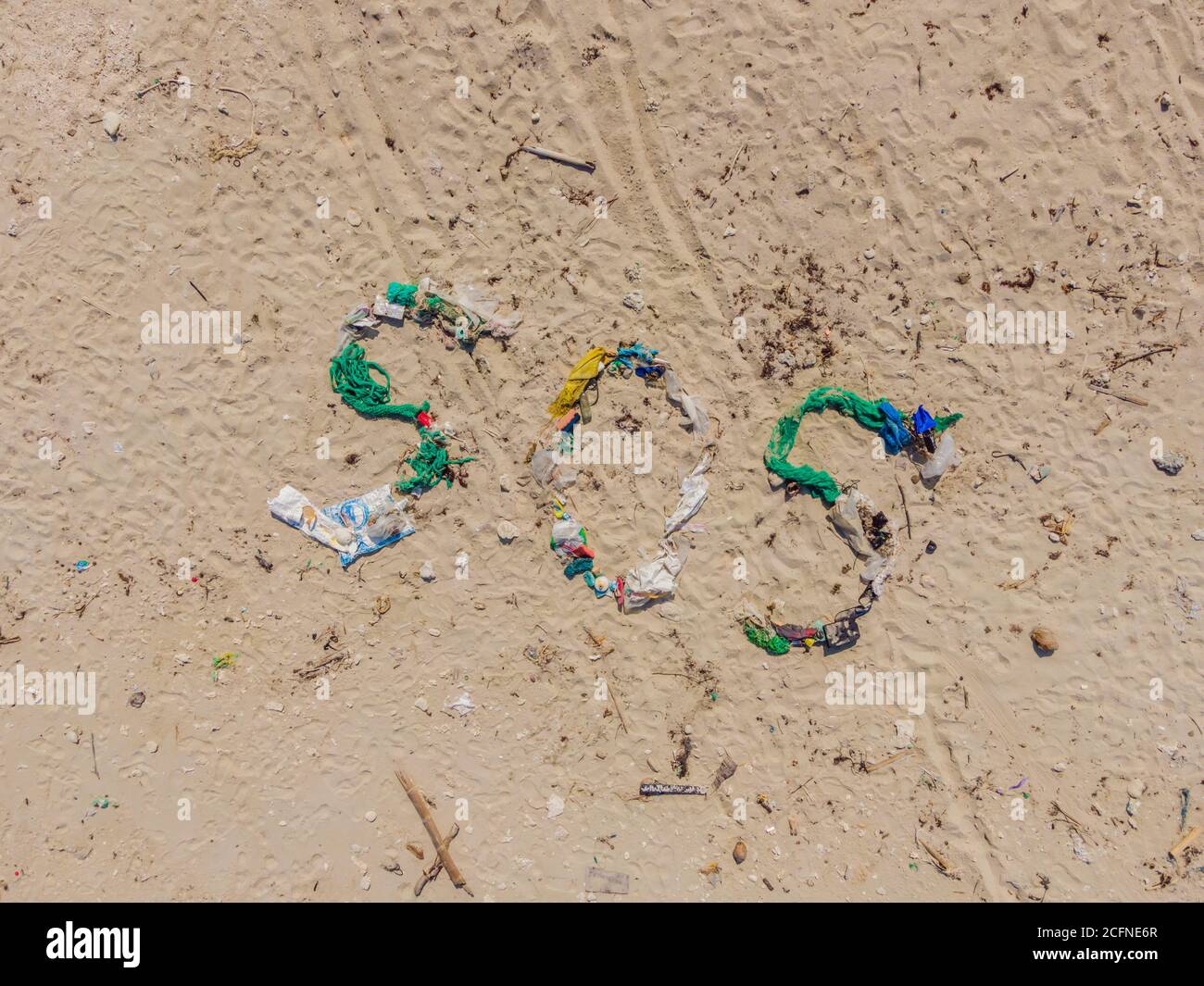 Environmental problem. Ecology concept. Plastic on the beach with sos ...