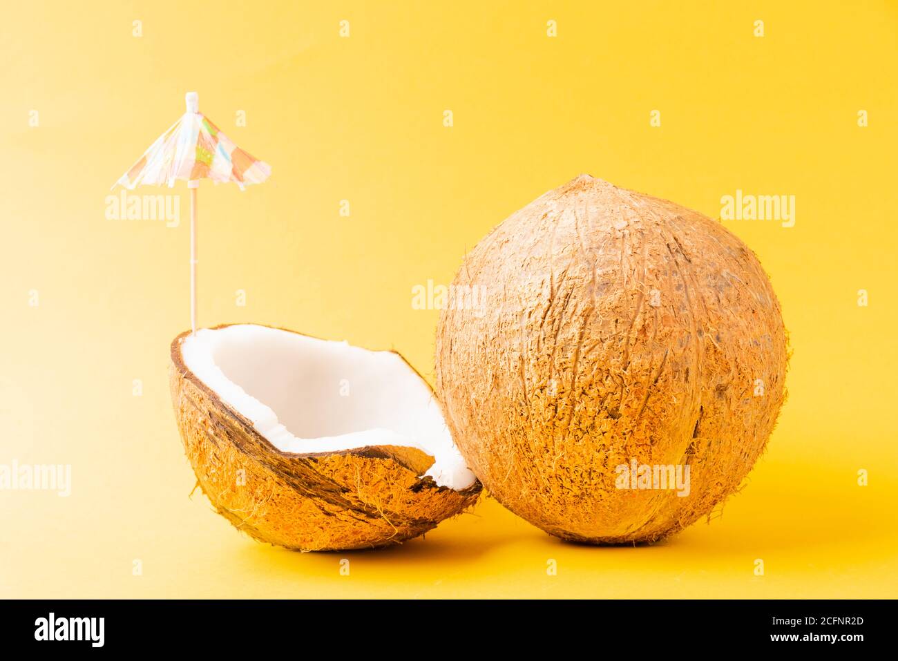 Happy coconuts day concept, fresh coconut and sun umbrella, studio shot ...