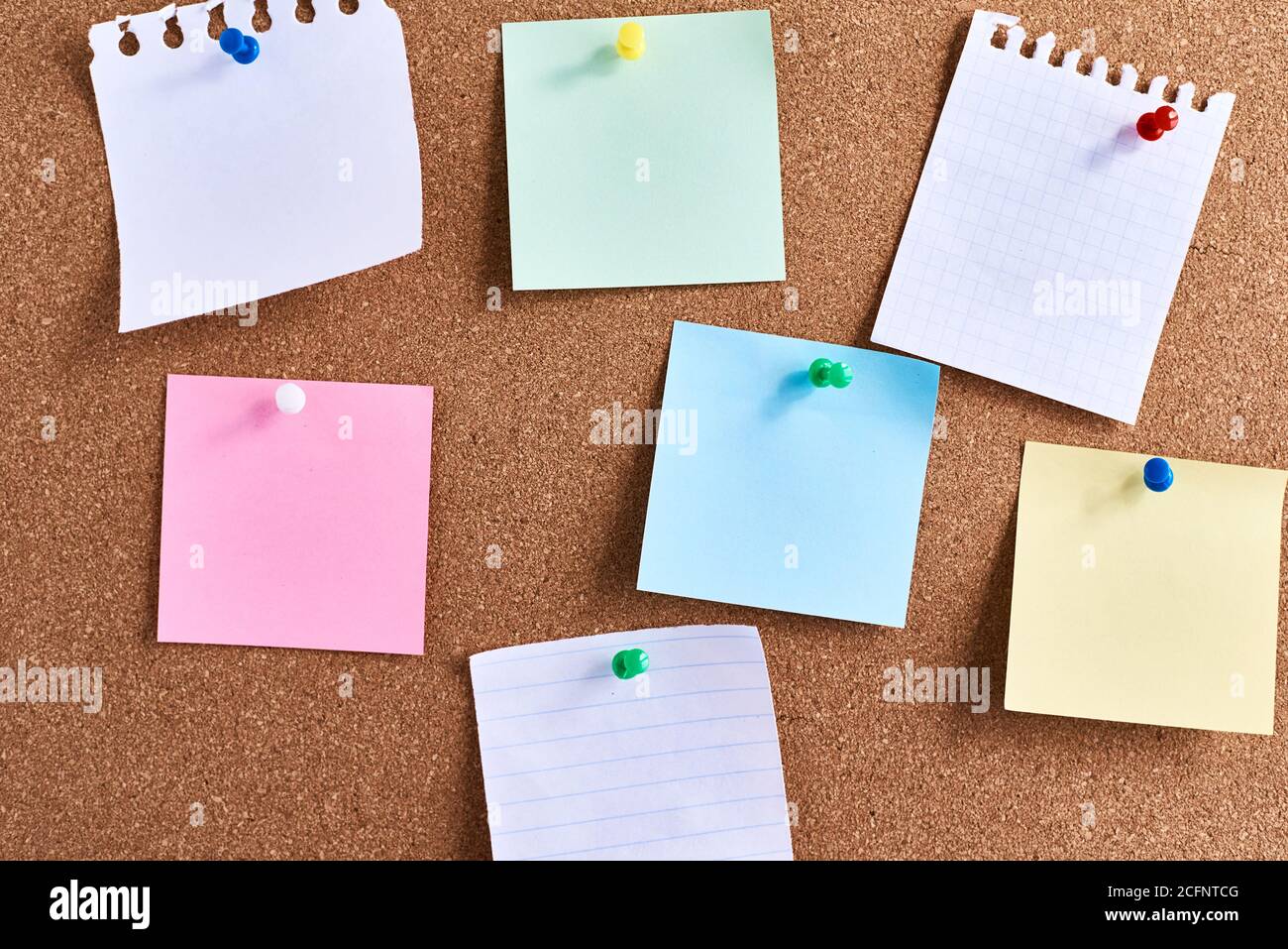 Sticky notes pinned on cork board. Planning and brainstorming concept ...