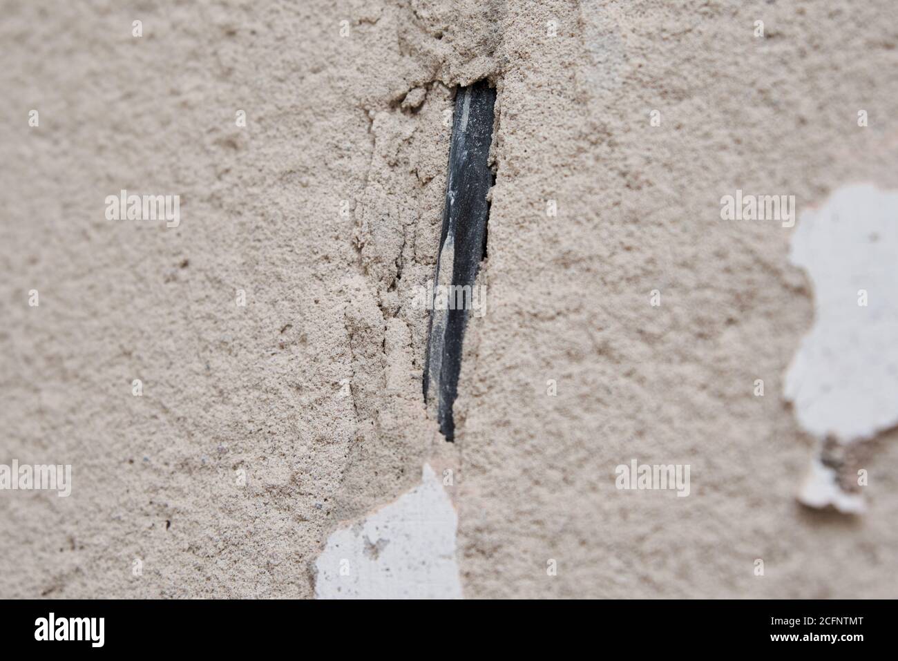 Old electrical cables in brick wall. Danger wiring Stock Photo - Alamy