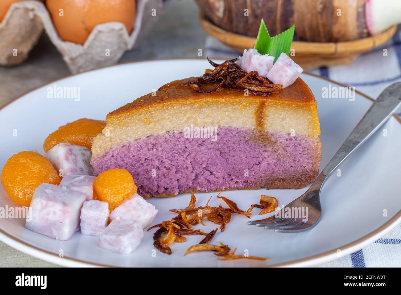 close-up of taro chiffon cake topped with Thai taro custard and fried ...