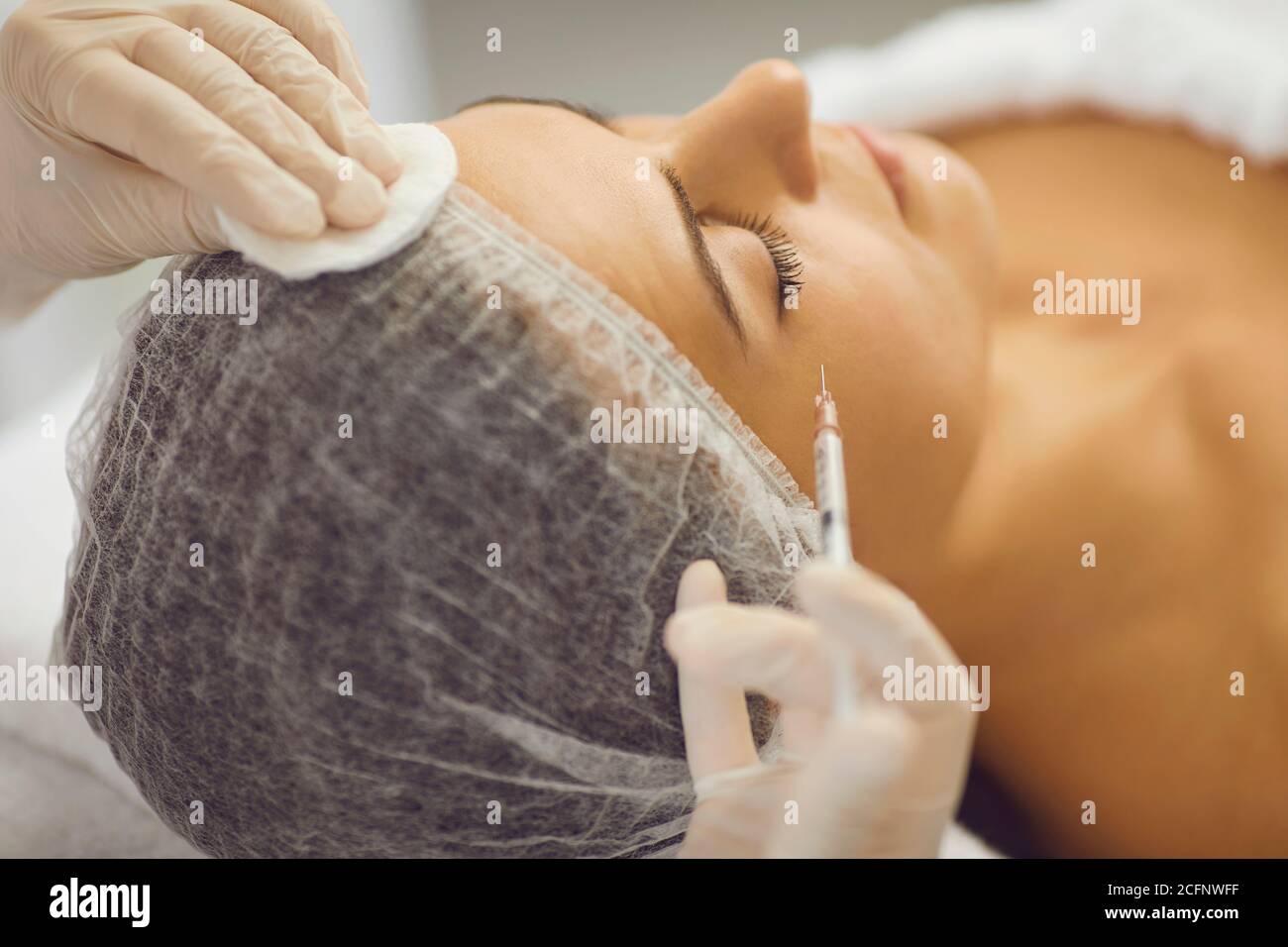 Hands of woman cosmetologist making botox injection for woman in beauty ...