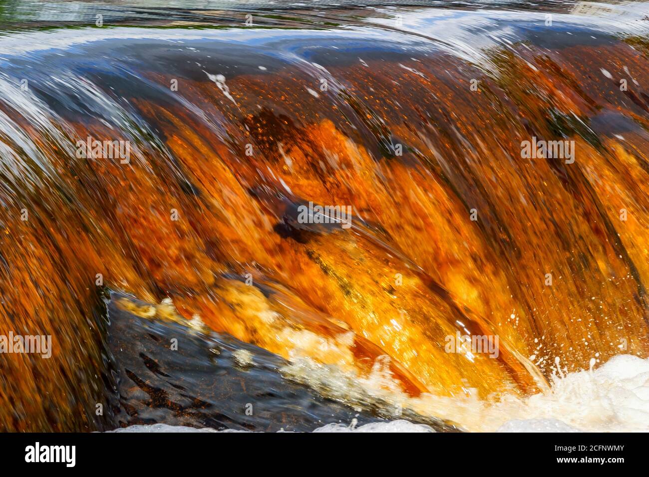 Rushing water in a waterfall Stock Photo - Alamy