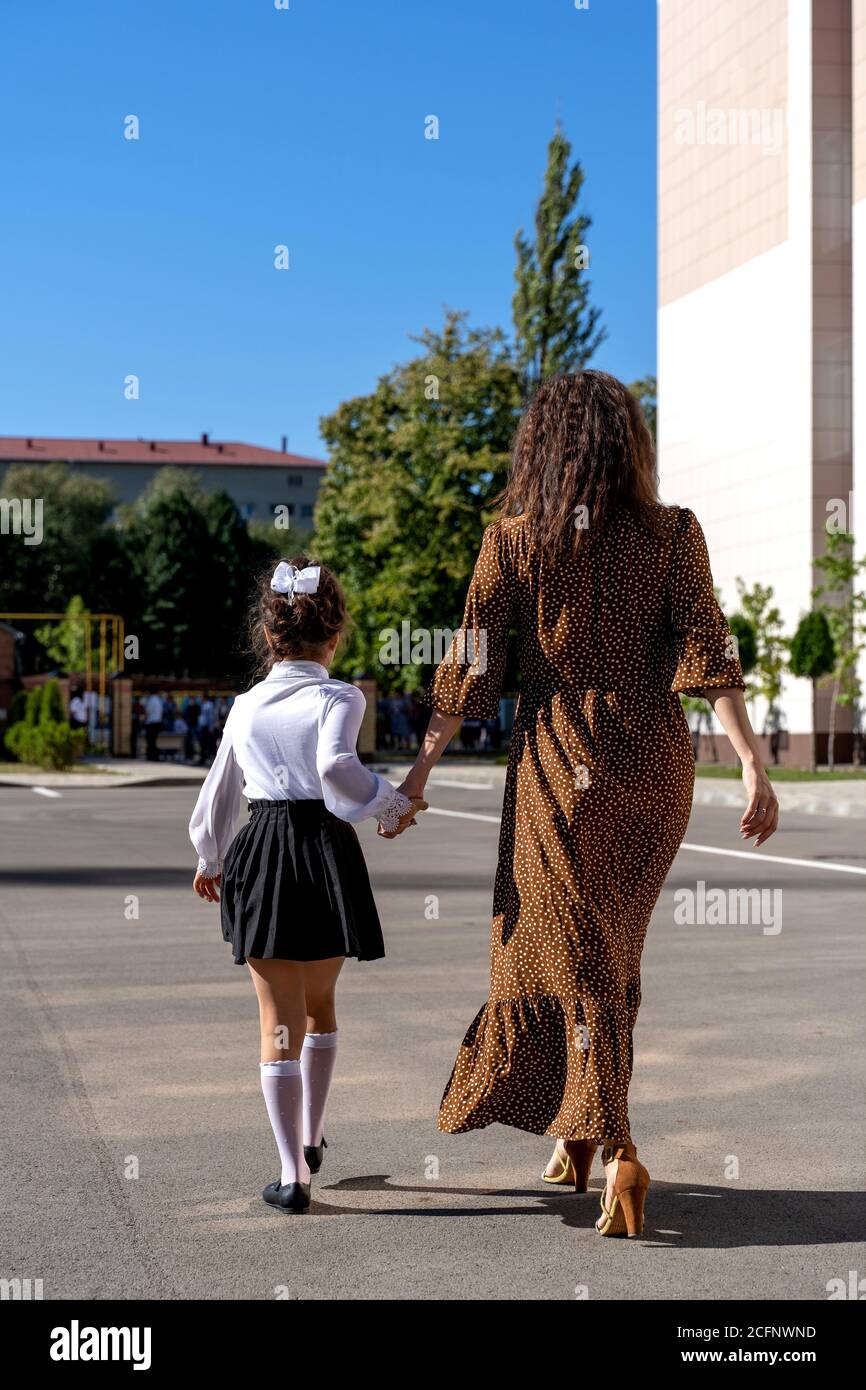 mom takes her daughter to first grade school Stock Photo - Alamy