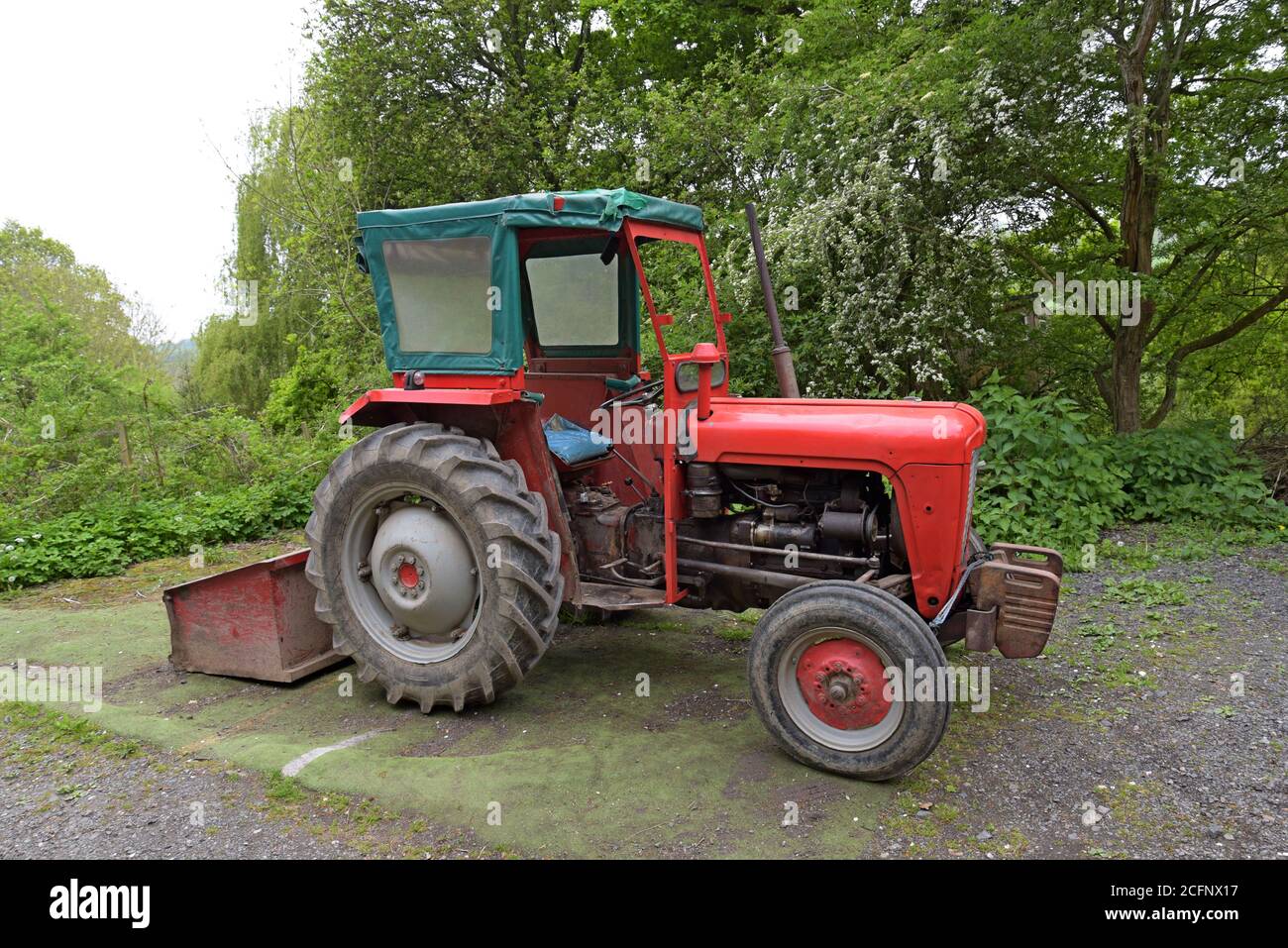 A vintage Massey Ferguson 35 tractor with transport box attached, on a ...