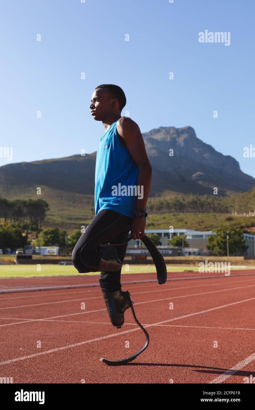 Male athlete with prosthetic leg performing stretching exercise Stock ...